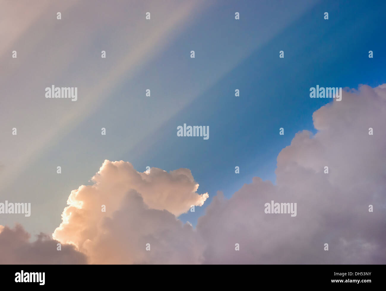 Suns rays beaming from behind clouds Stock Photo - Alamy