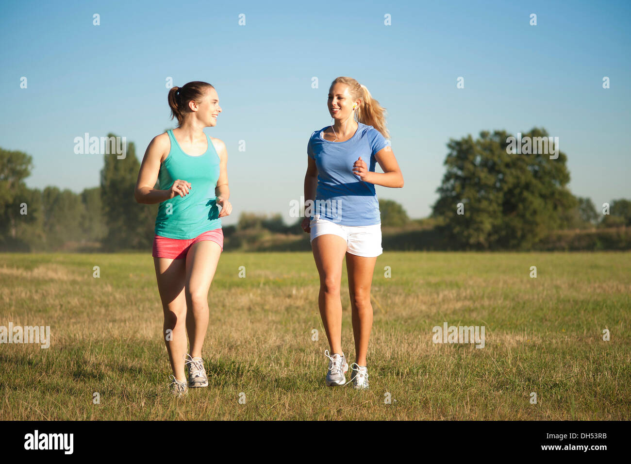 Two young women jogging outdoors Stock Photo - Alamy