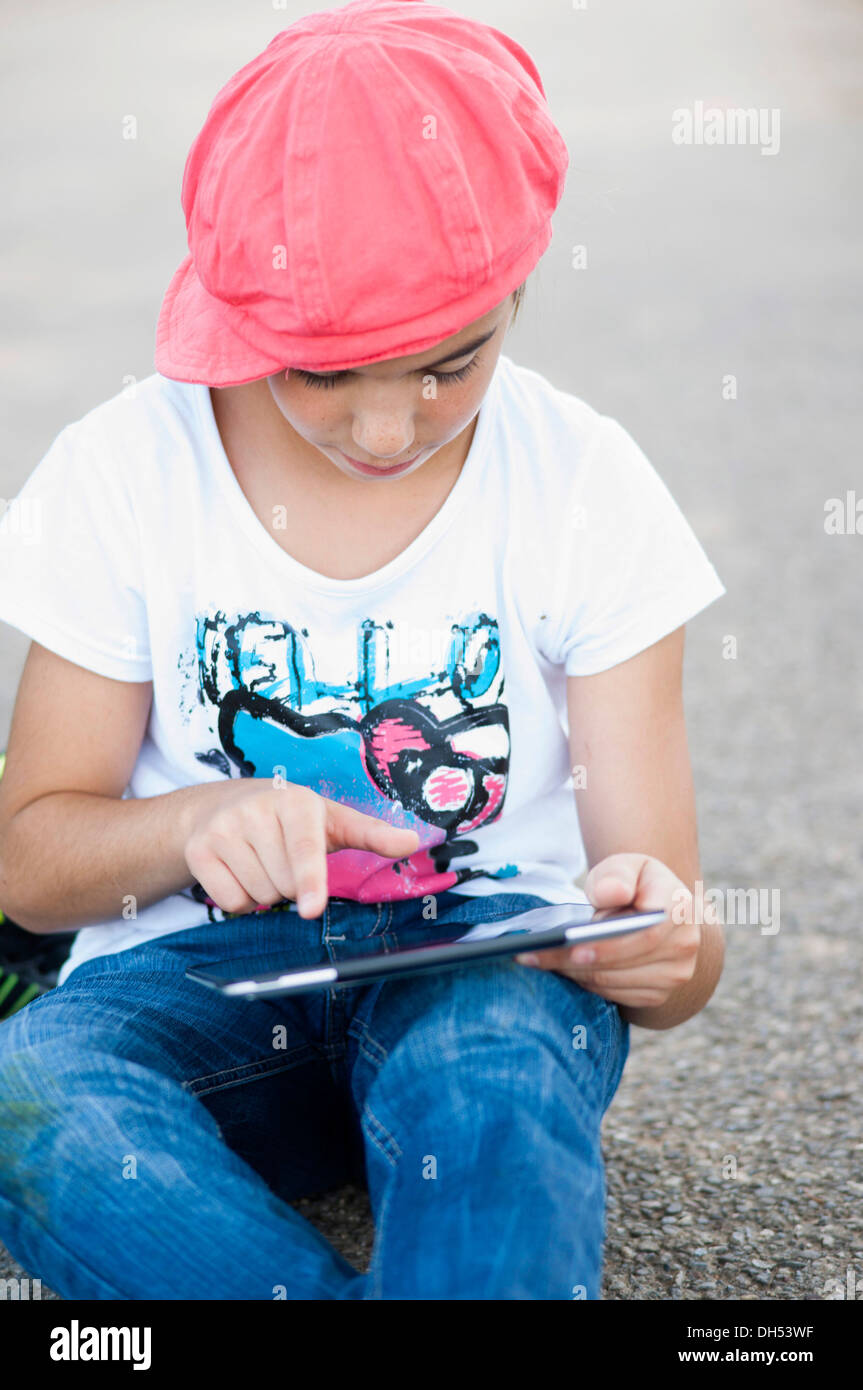 Girl playing on her tablet computer Stock Photo - Alamy