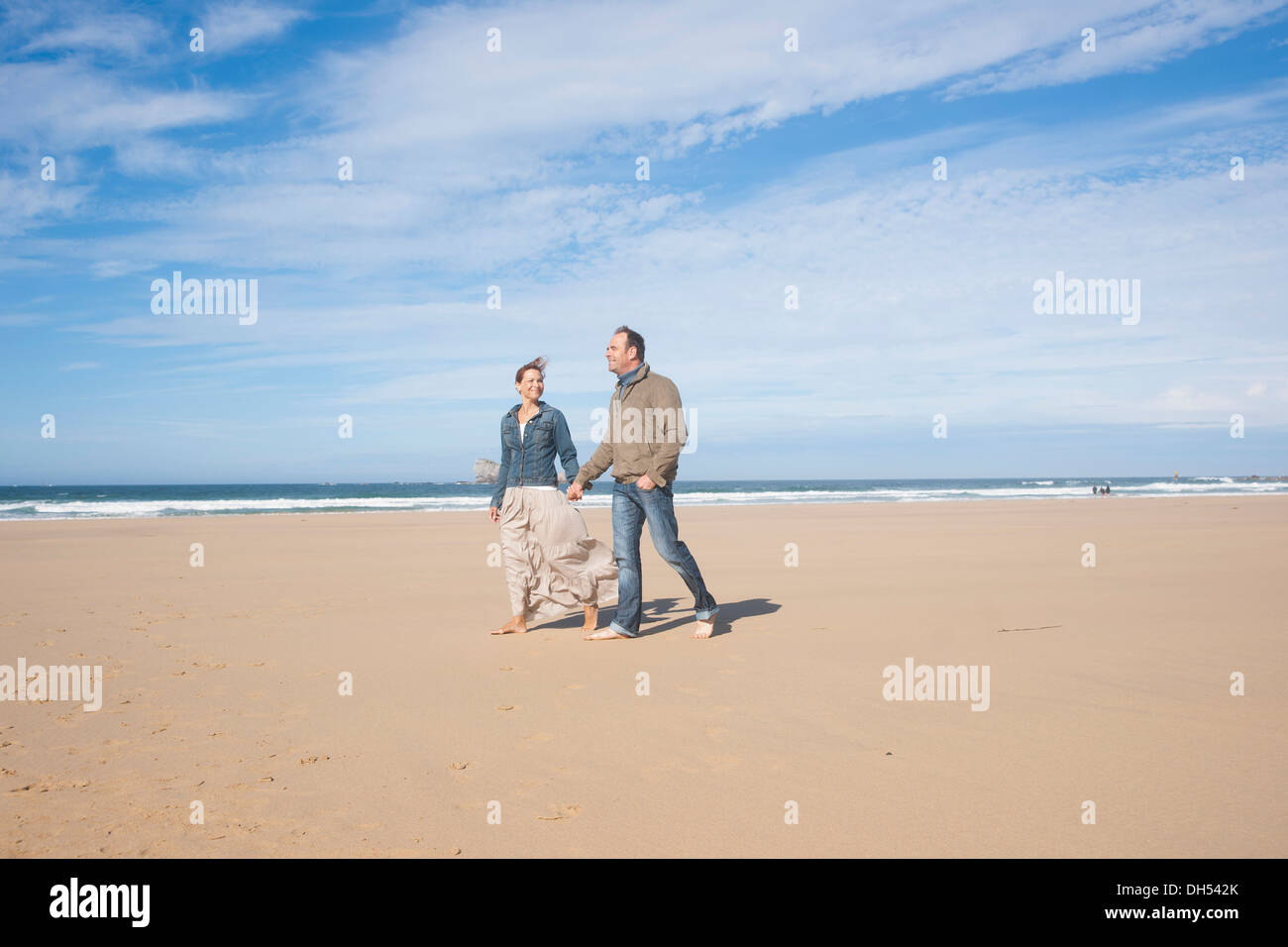 Happy woman strolls along sandy hi-res stock photography and images - Alamy