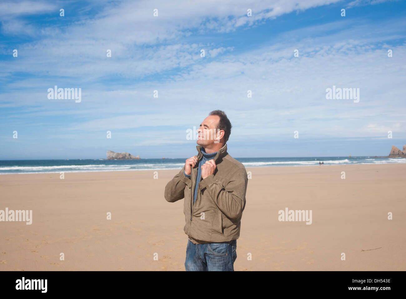 Man walking along the beach Stock Photo - Alamy