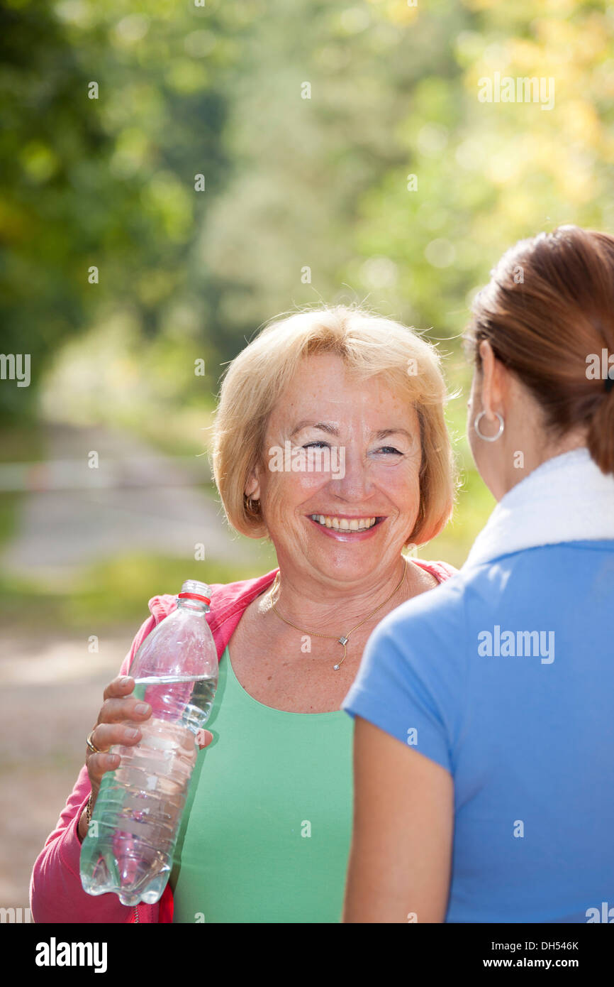 Women taking a break while doing sports outdoors Stock Photo - Alamy
