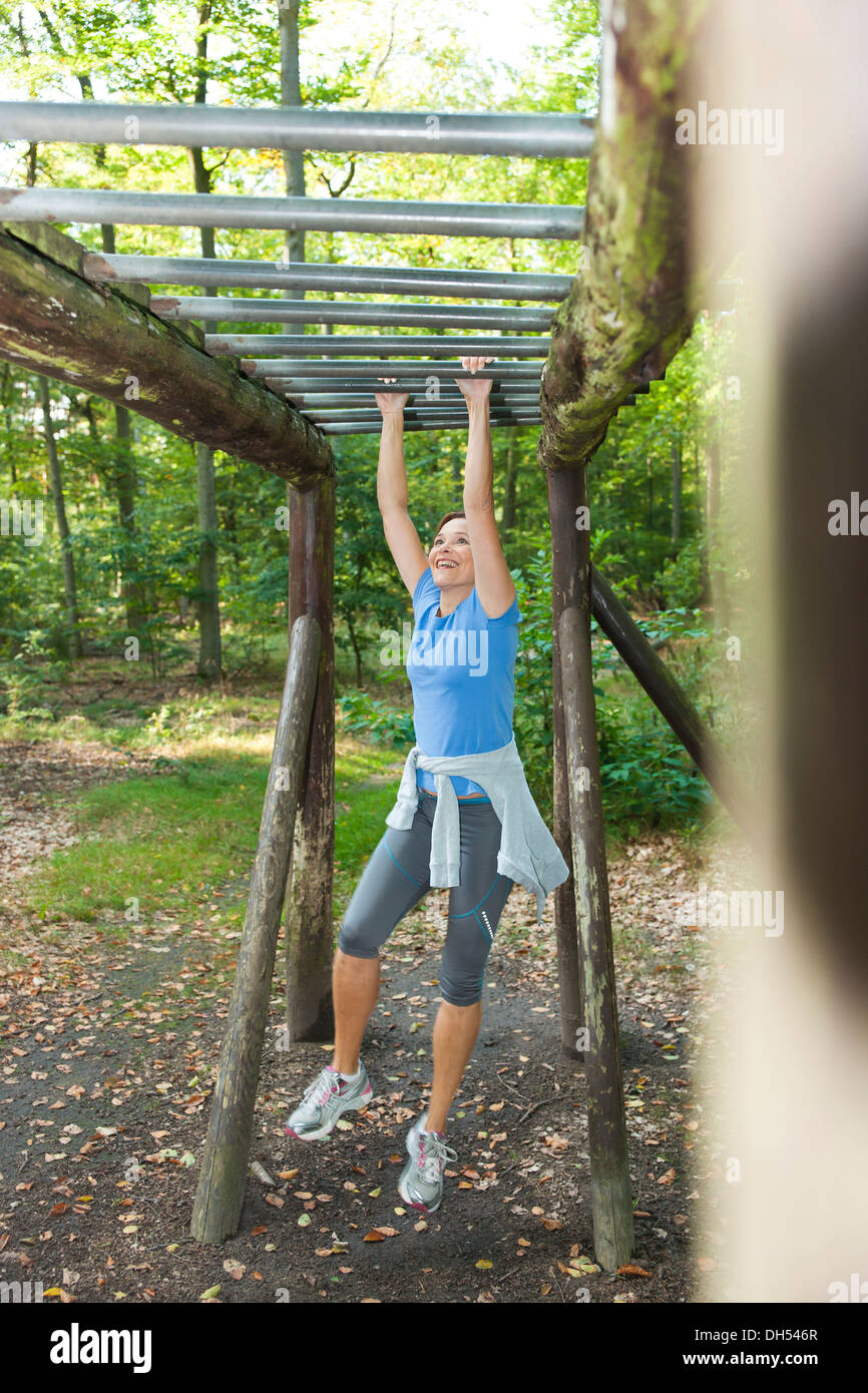 Woman exercising on an outdoor fitness trail Stock Photo - Alamy
