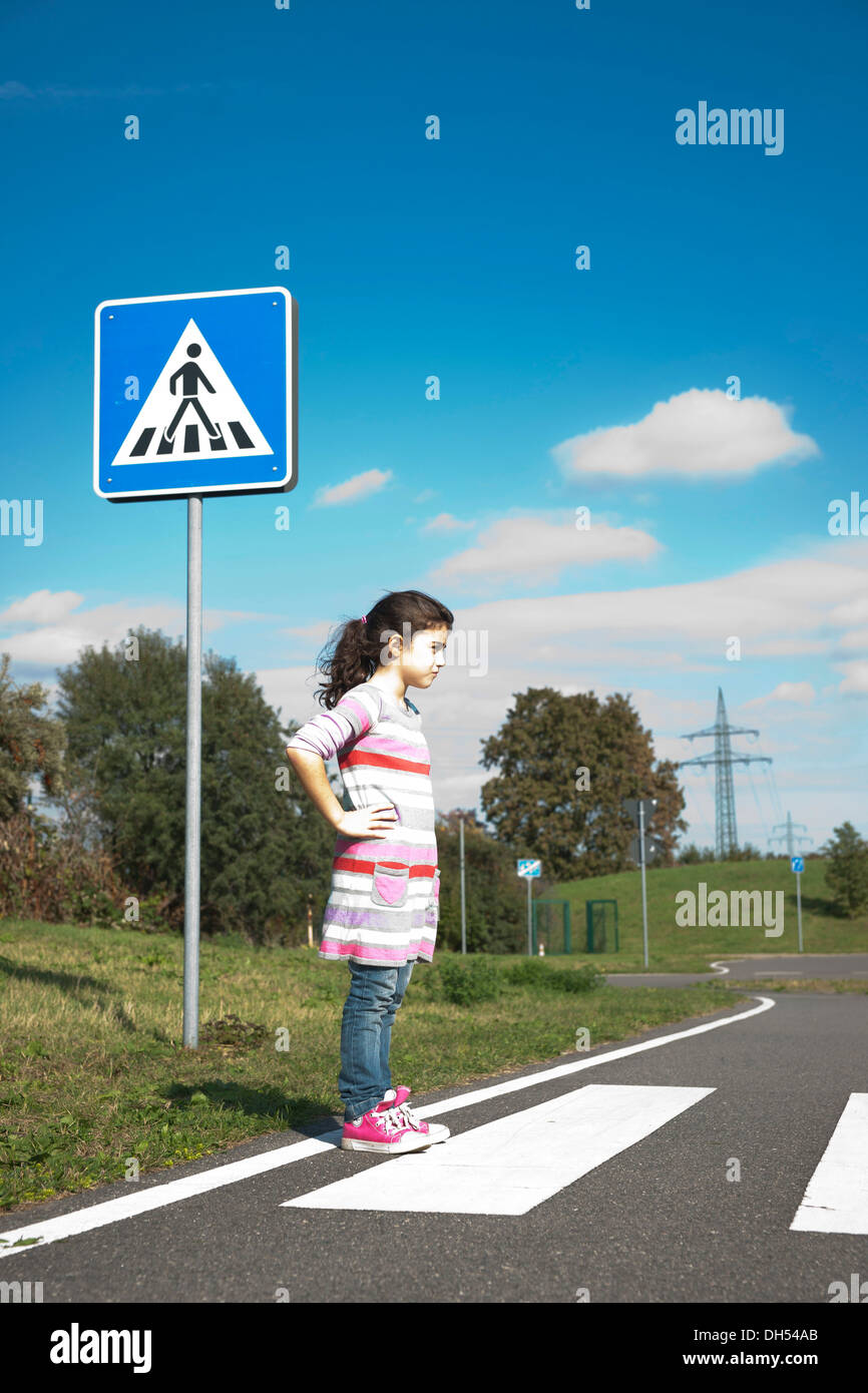 Girl waiting at a zebra crossing Stock Photo - Alamy