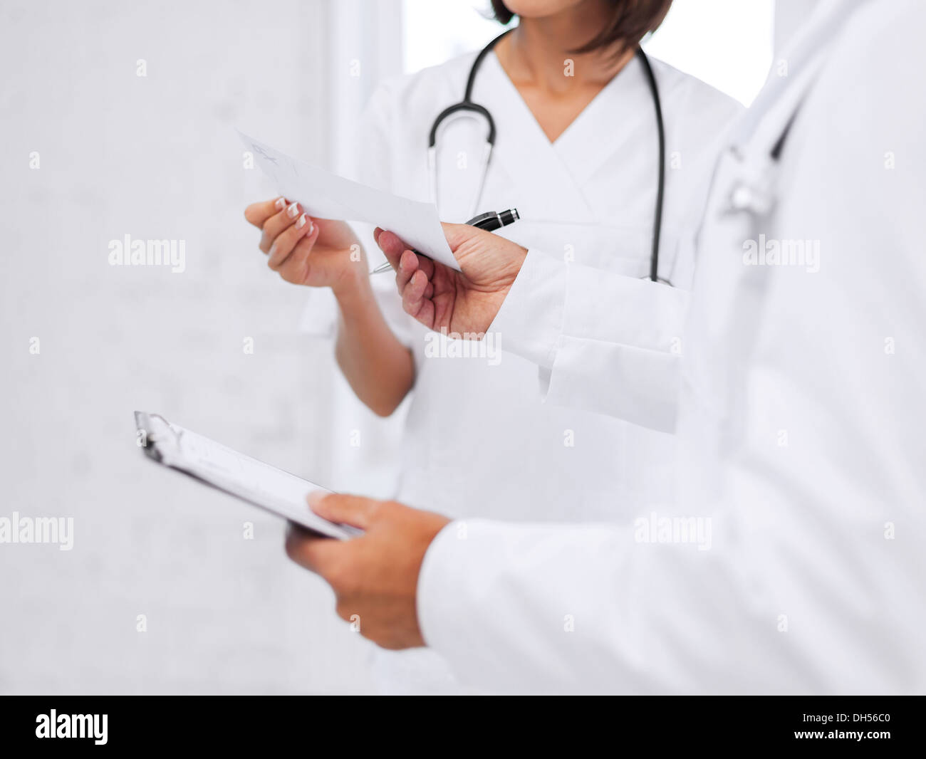 two doctors writing prescription Stock Photo - Alamy