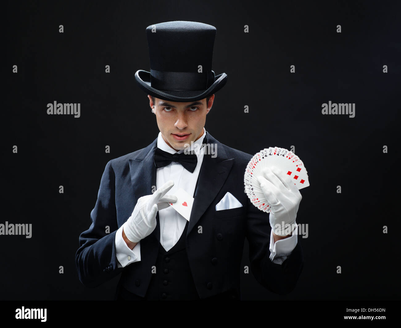 magician showing trick with playing cards Stock Photo - Alamy