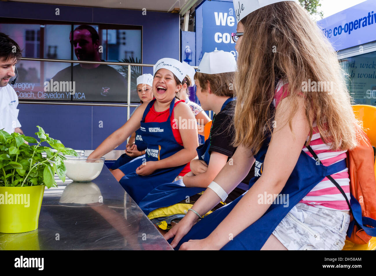 Young girl laughing enjoying a demonstration on how to make homemade ...