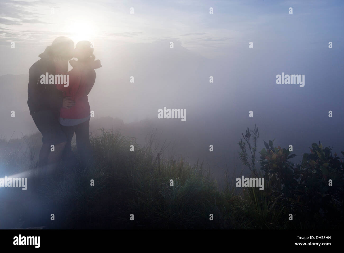 Couple kissing in the fog on the Gunung Agung volcano, Bangli, Bali ...