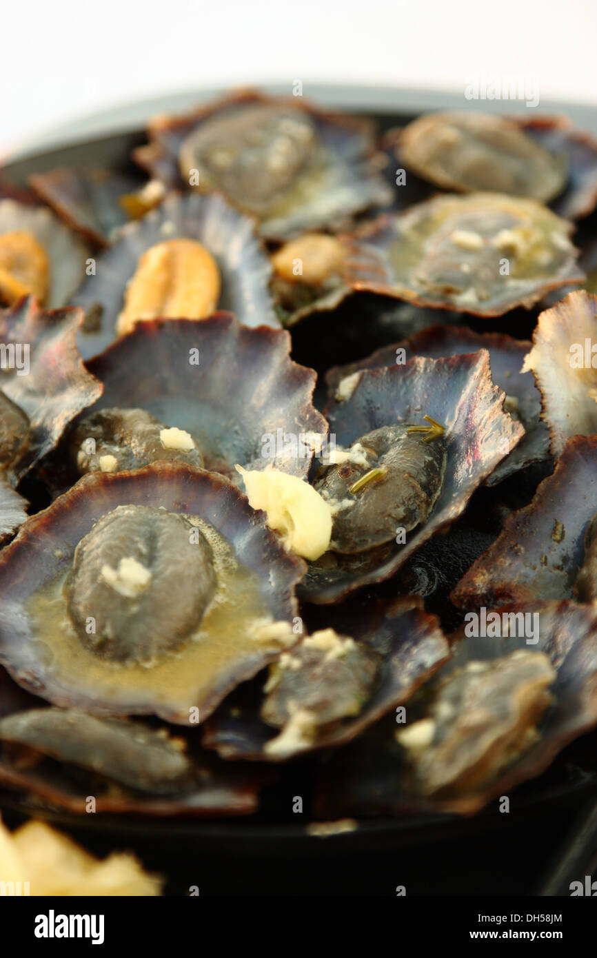 Grilled limpets with lemon. Madeira's traditional dish Stock Photo - Alamy