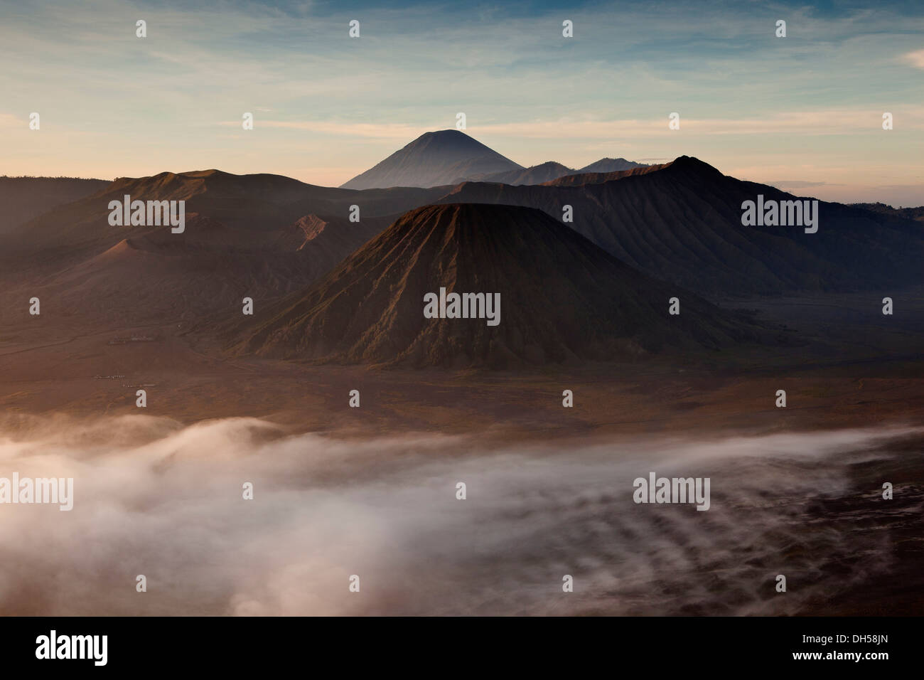 Morning fog in the Tengger Caldera with Mount Bromo volcano, left ...