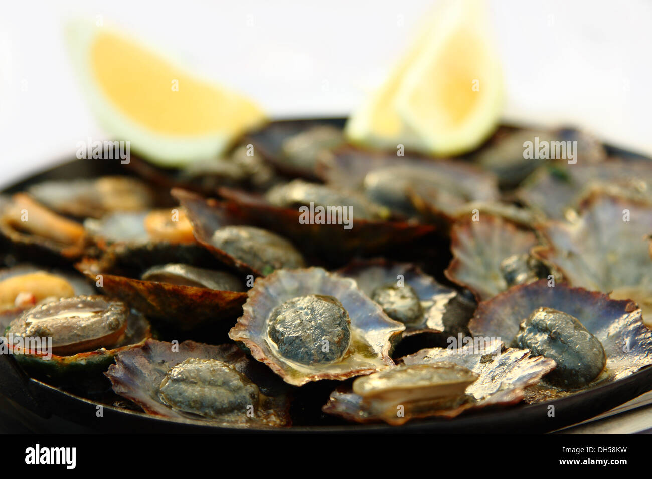 Grilled limpets with lemon. Madeira's traditional dish Stock Photo - Alamy