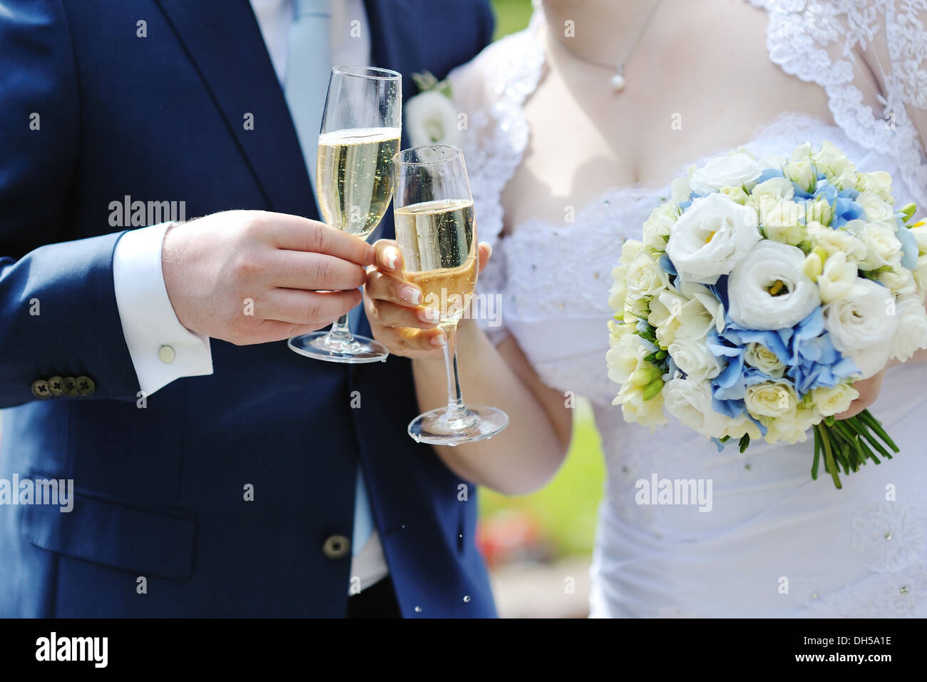 Bride and groom making a toast with champagne glasses after wedding ...