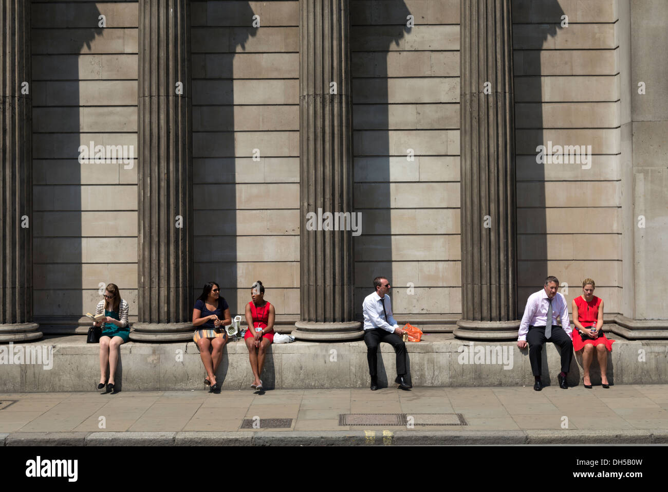 Office workers having their lunch break outside the Bank of England ...
