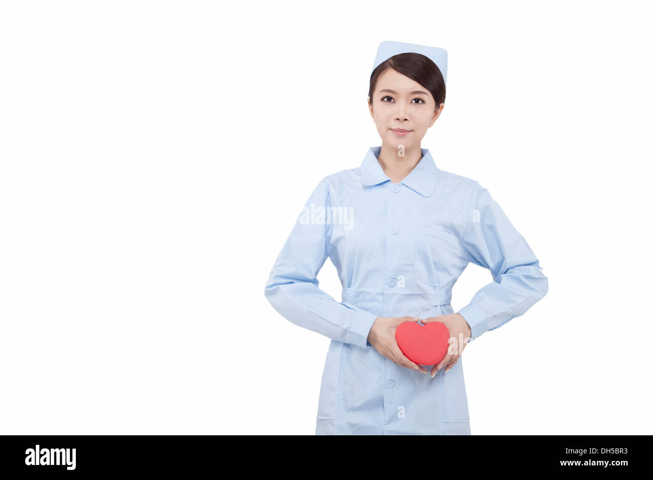 Oriental female nurse holding a heart Stock Photo - Alamy