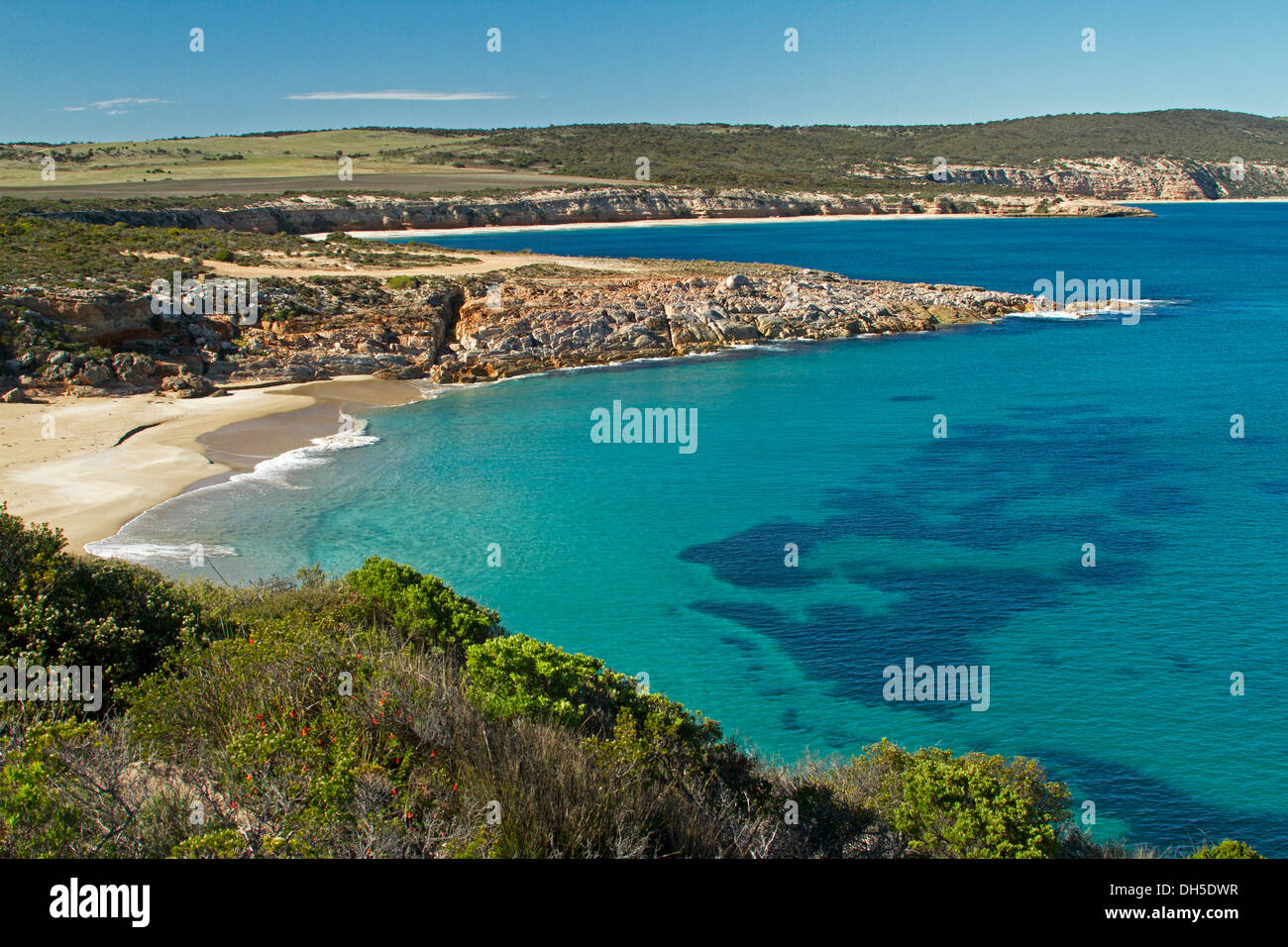 Deserted beach, secluded bay, cliffs and turquoise water of ocean at ...