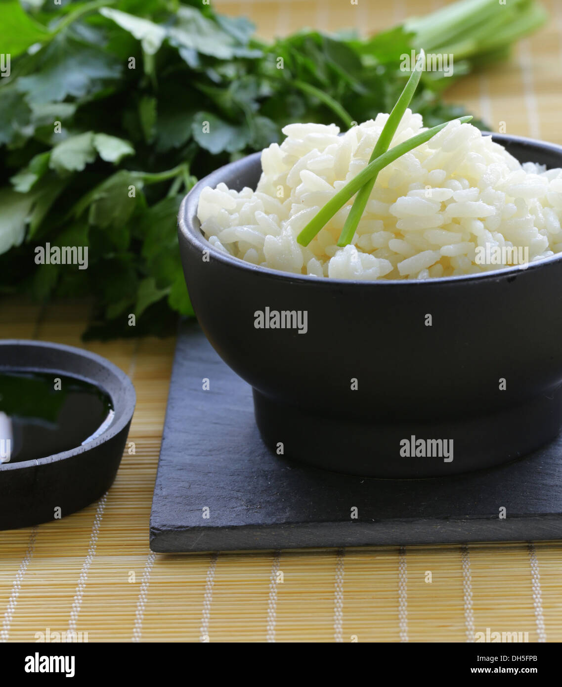 boiled white rice in a black bowl, Asian style Stock Photo - Alamy