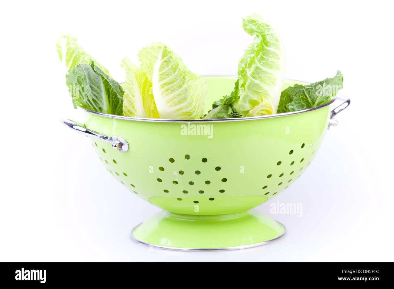 Vegetable in colander isolated on white background Stock Photo - Alamy