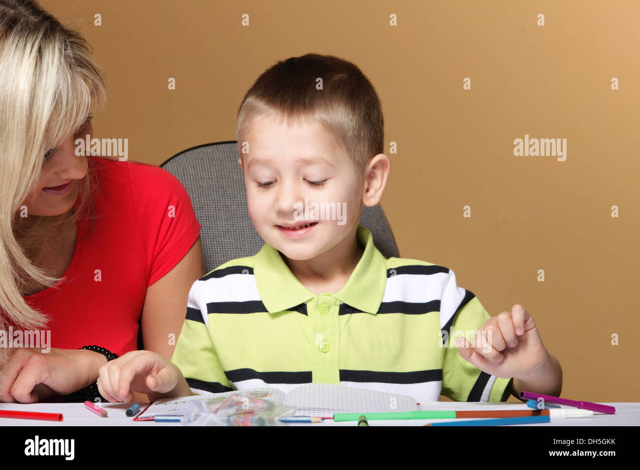 mother and son drawing together, mom helping with homework daycare ...