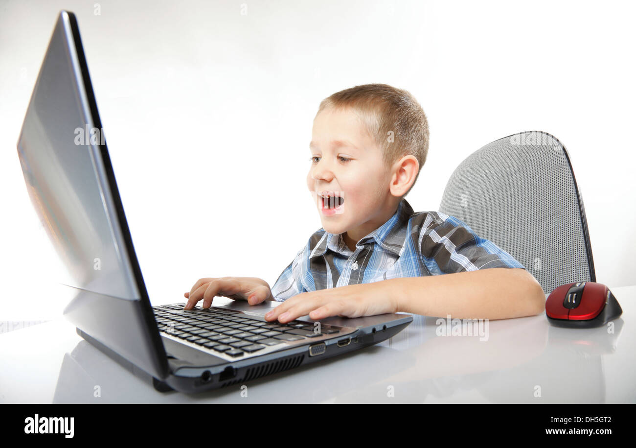 Computer addiction emotional child boy with laptop notebook playing ...