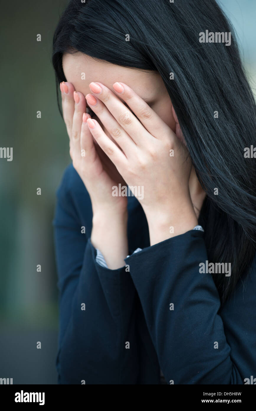 Portrait of young depressed woman - hands on face Stock Photo - Alamy