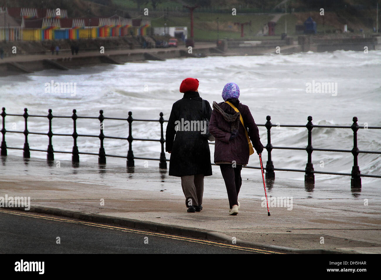 Two women walking on sea front Stock Photo - Alamy