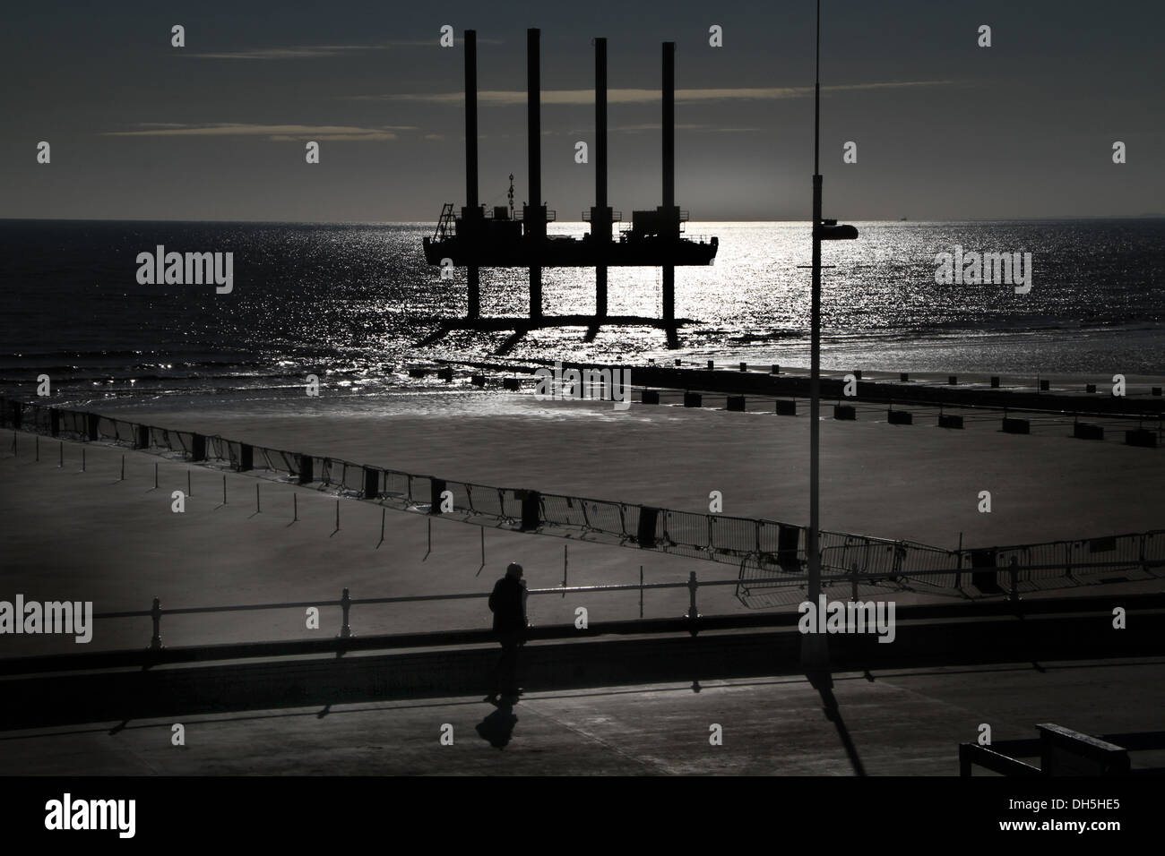 Silhouetted work platforms on bright morning at low tide in the north ...