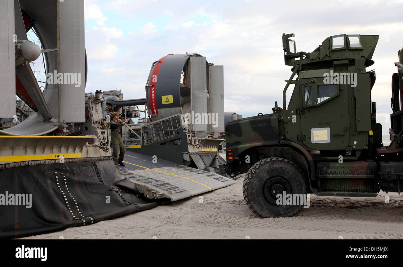A U.S. Navy landing craft, air cushion (LCAC) loadmaster directs a ...