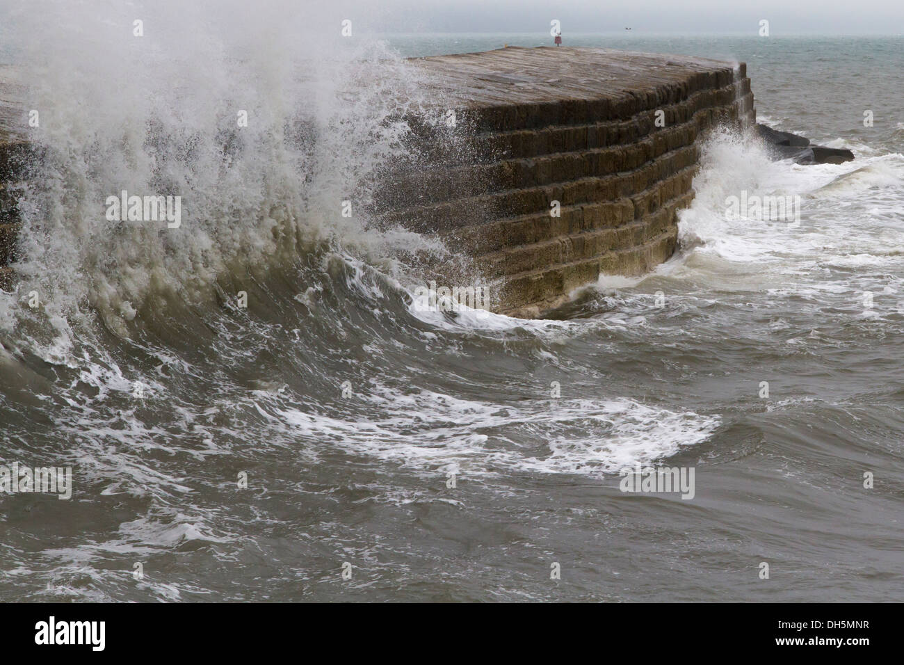 Waves crashing over The Cobb – which protects the harbour. Famous scene ...