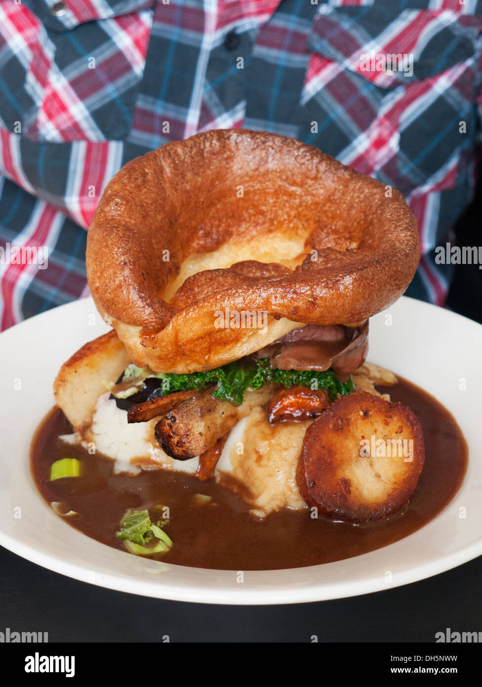 Large Yorkshire pudding on top of a Sunday roast dinner Stock Photo - Alamy