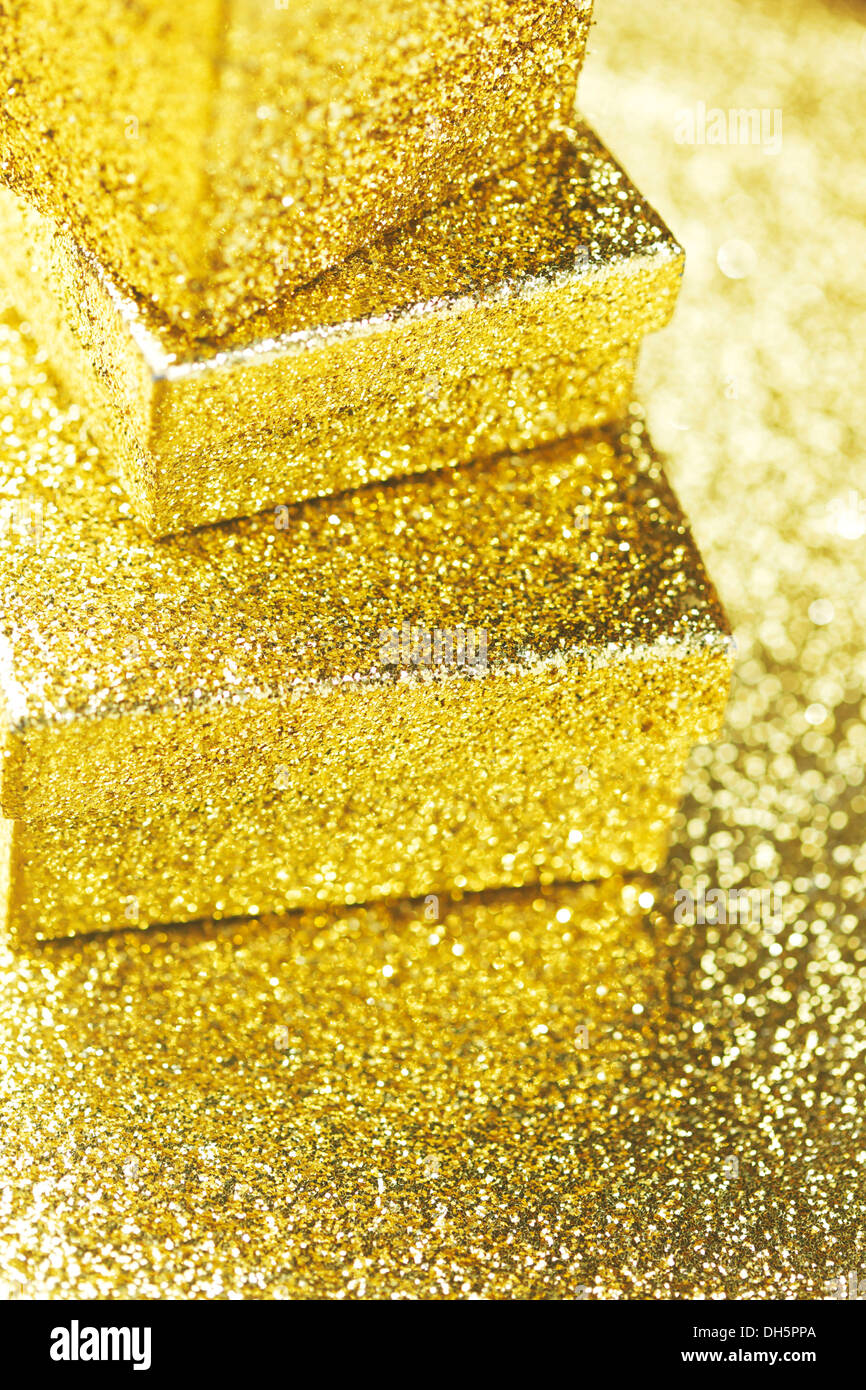 Golden boxes with holiday gifts on shiny glitter background Stock Photo ...
