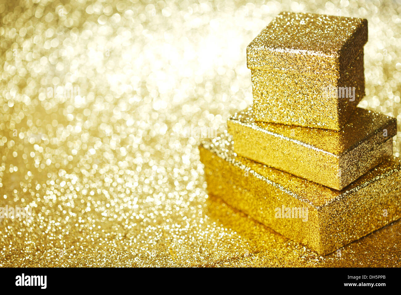 Golden boxes with holiday gifts on shiny glitter background Stock Photo ...