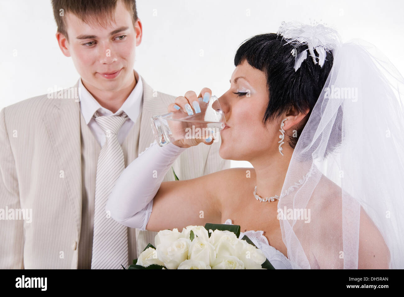 The groom and the bride drink water. White isolated Stock Photo - Alamy