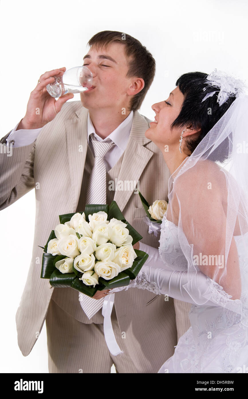 The groom and the bride drink water. White isolated Stock Photo - Alamy