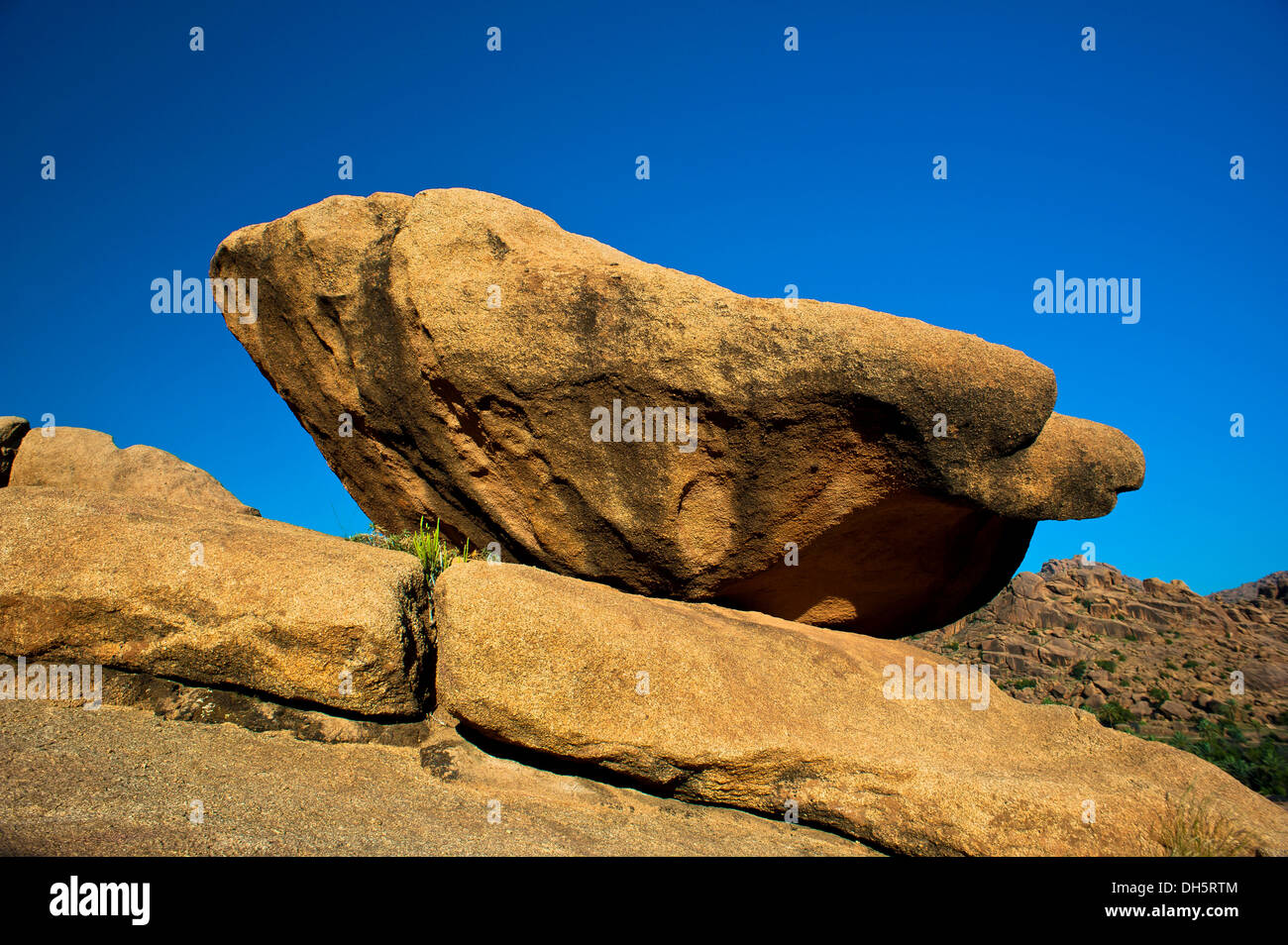 Impressive granite boulder lying on a rock, Little Atlas mountain range ...