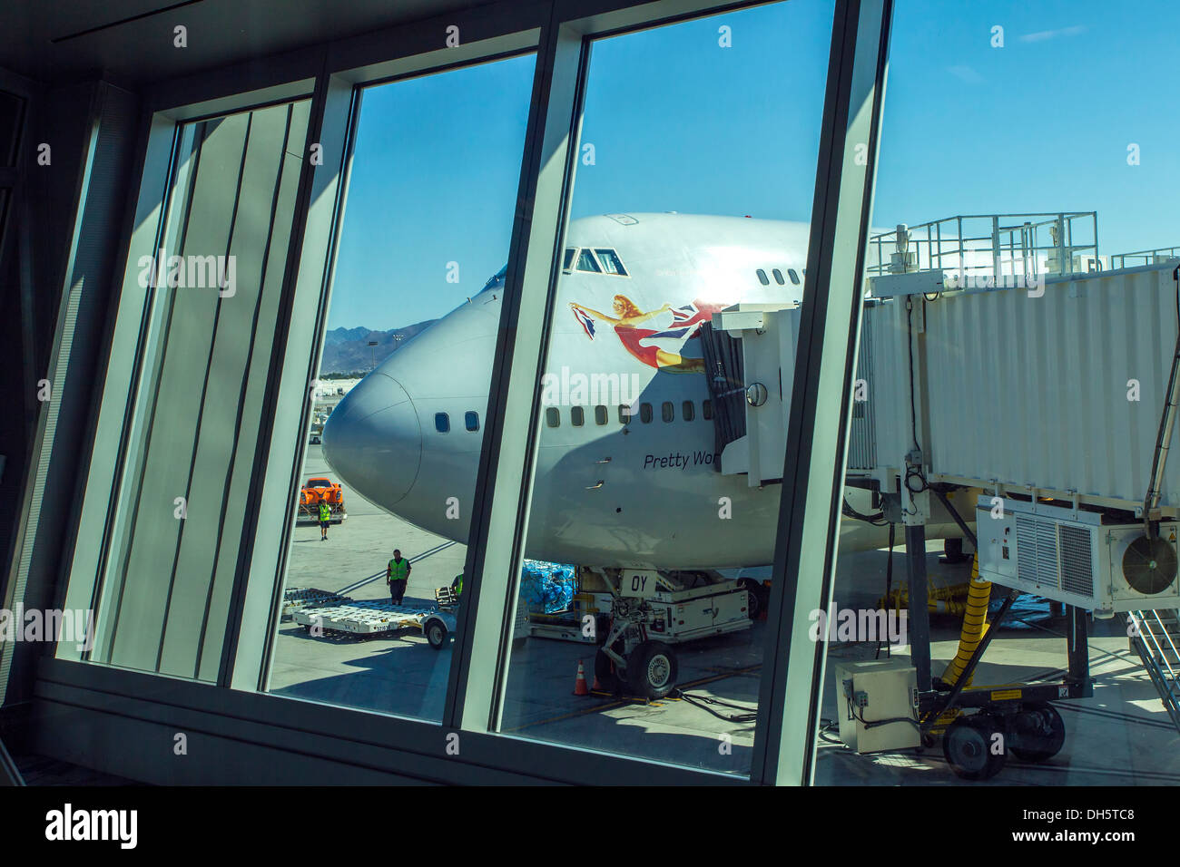 Inside terminal building looking out at a Virgin Atlantic plane Stock ...