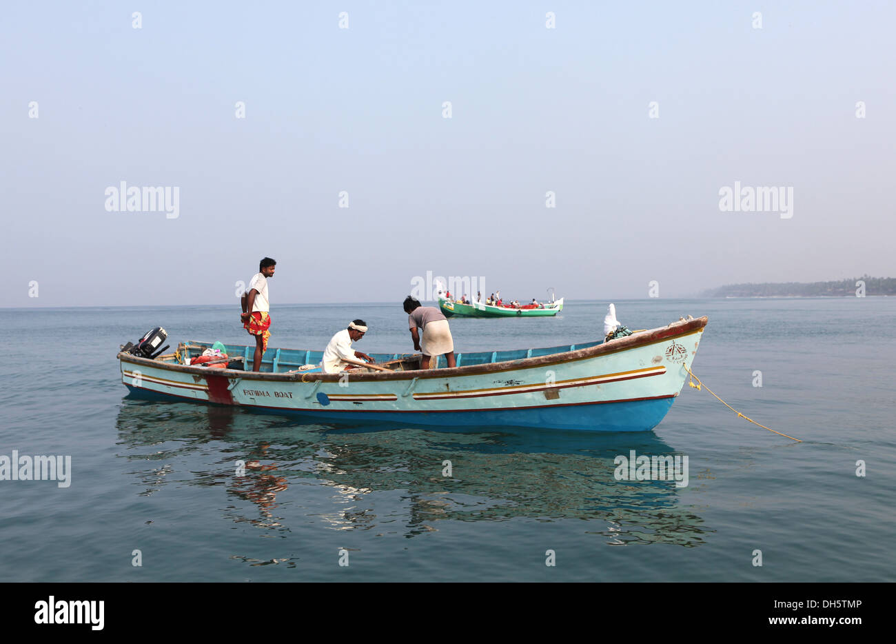 Local mussel fishermen in their boat off the coast, Varkala, Kerala ...