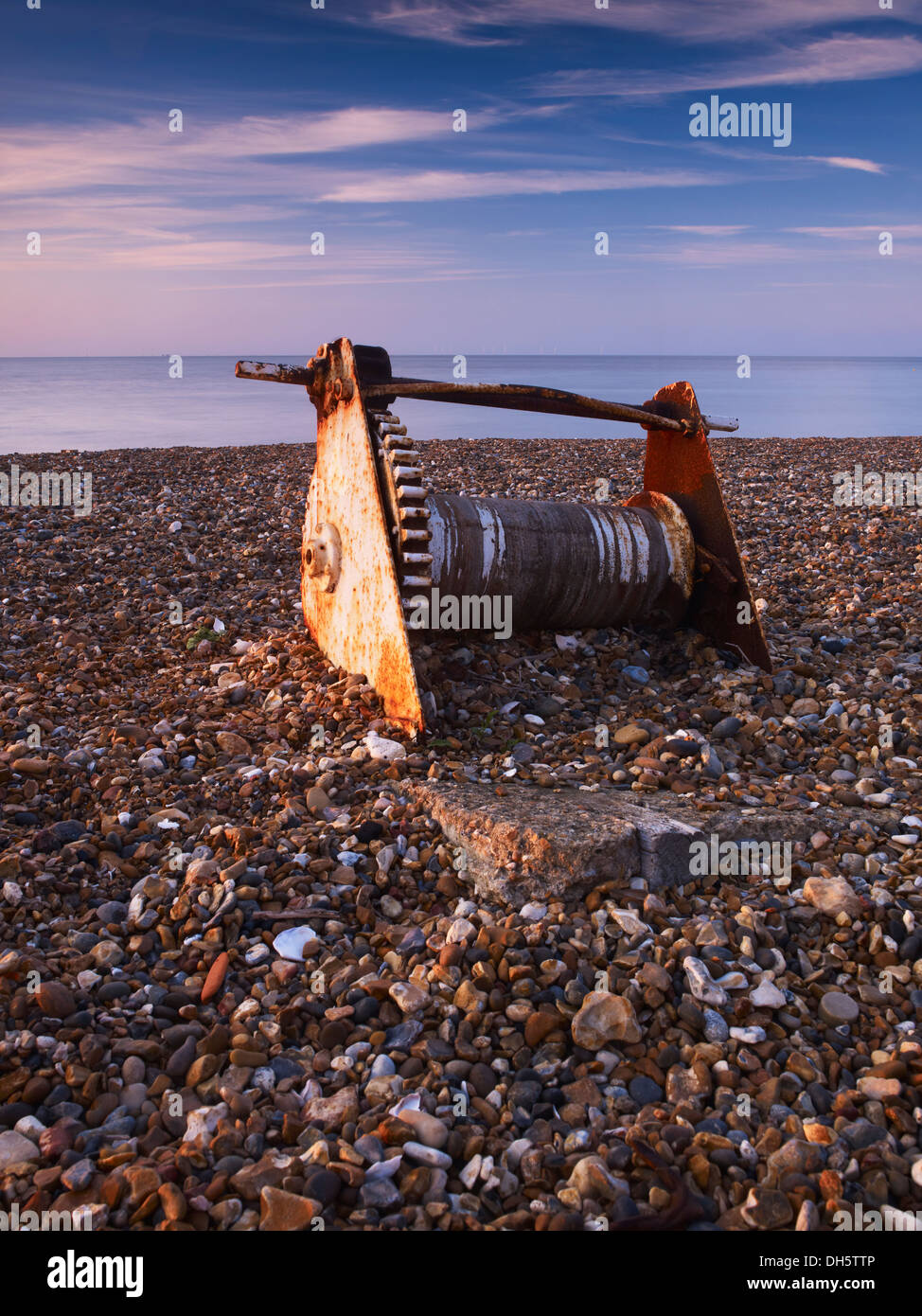 an old disused Beach winch in the pebbles on whitstable beach Kent uk ...