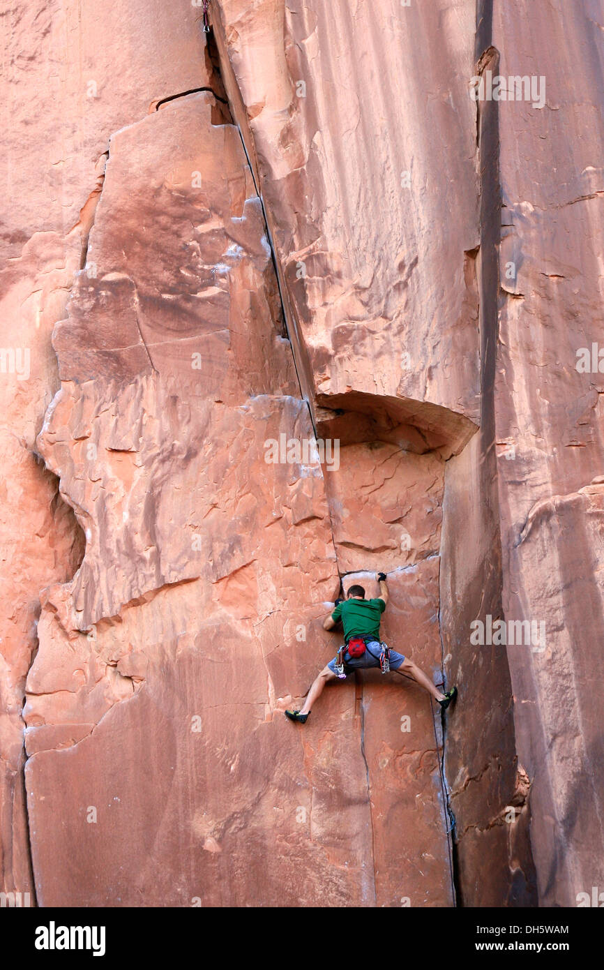 Rock climber climbing a rock wall, near Moab, Utah, USA Stock Photo - Alamy