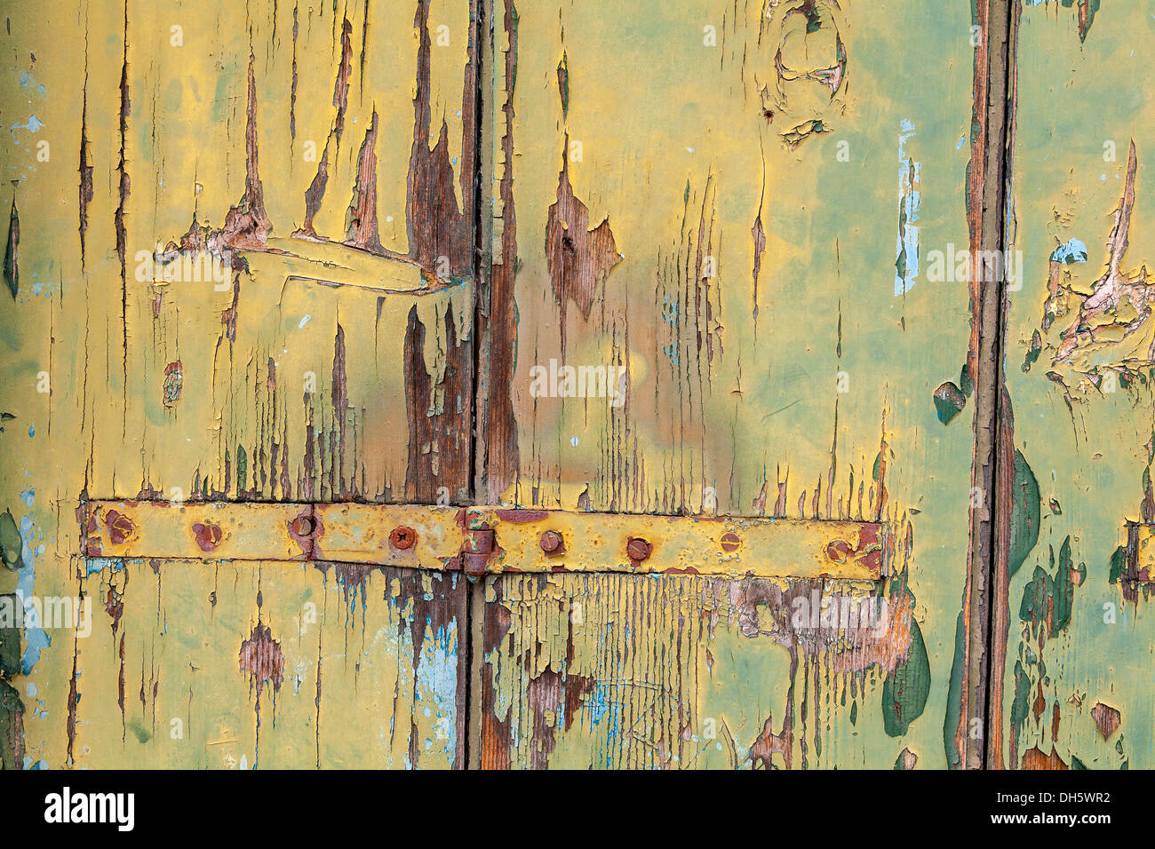 Weathered yellow wood paneling with rusty hinges Stock Photo - Alamy