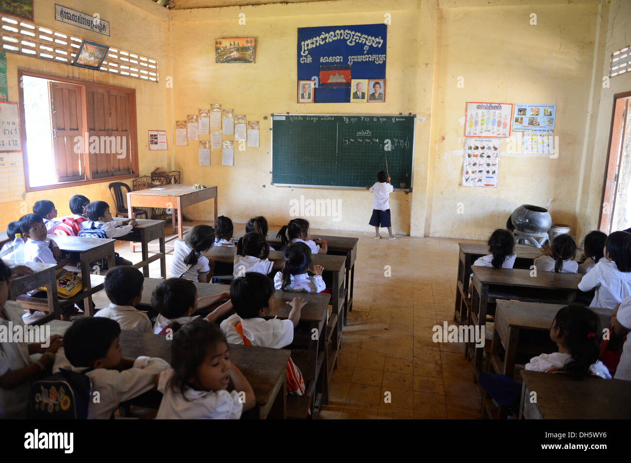 Phnom Penh, Cambodia. 11th Oct, 2013. A girl points to Khmer script on ...