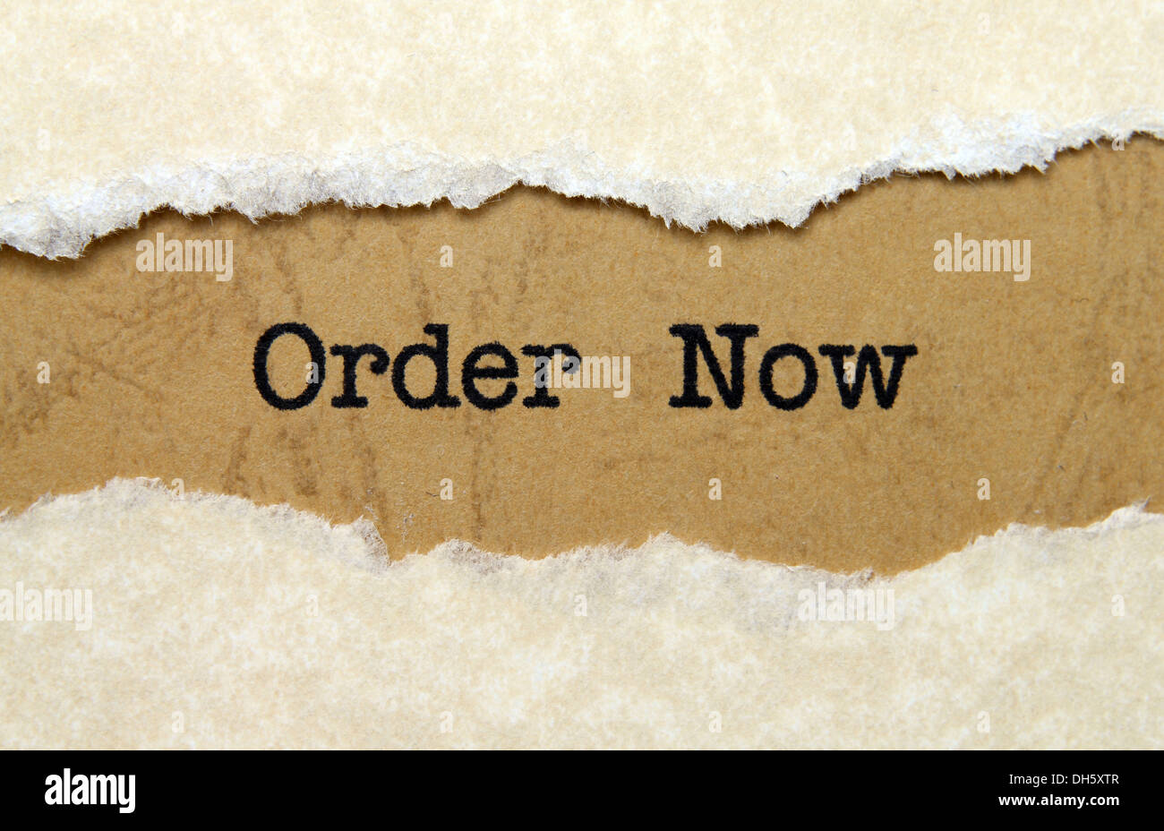 Order now text on paper hole Stock Photo - Alamy