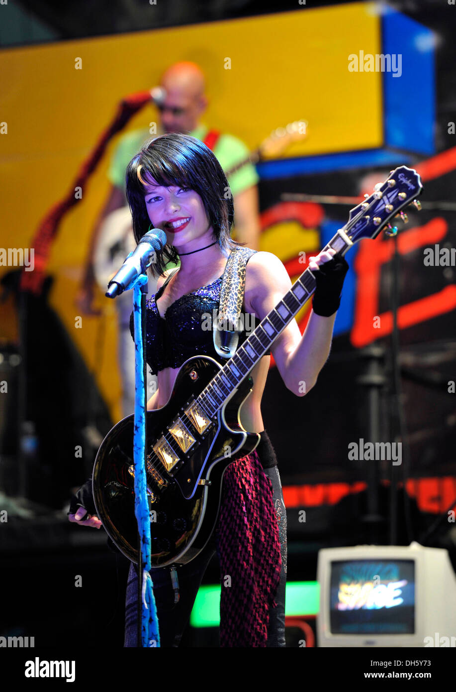 Singer with a guitar performing a free music show at the centre of the ...