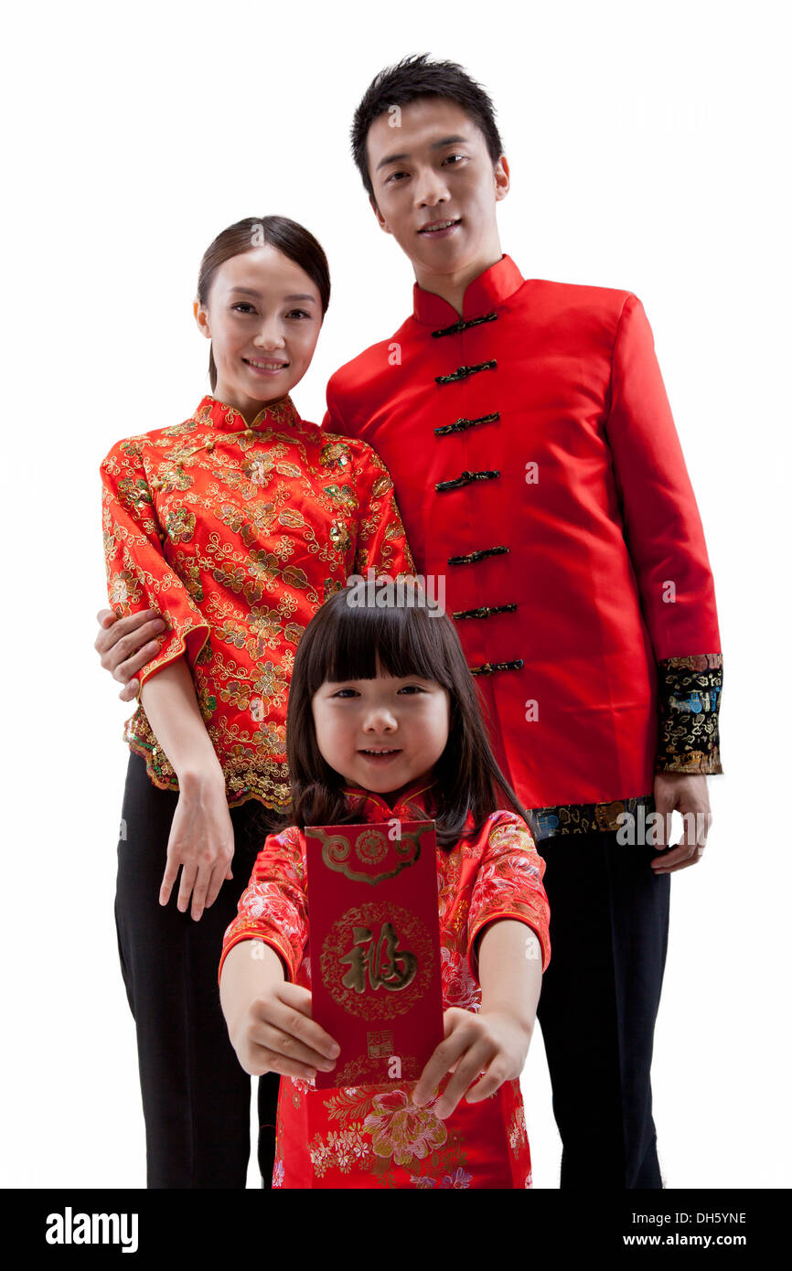 Family of three wearing costume and red envelope Stock Photo - Alamy