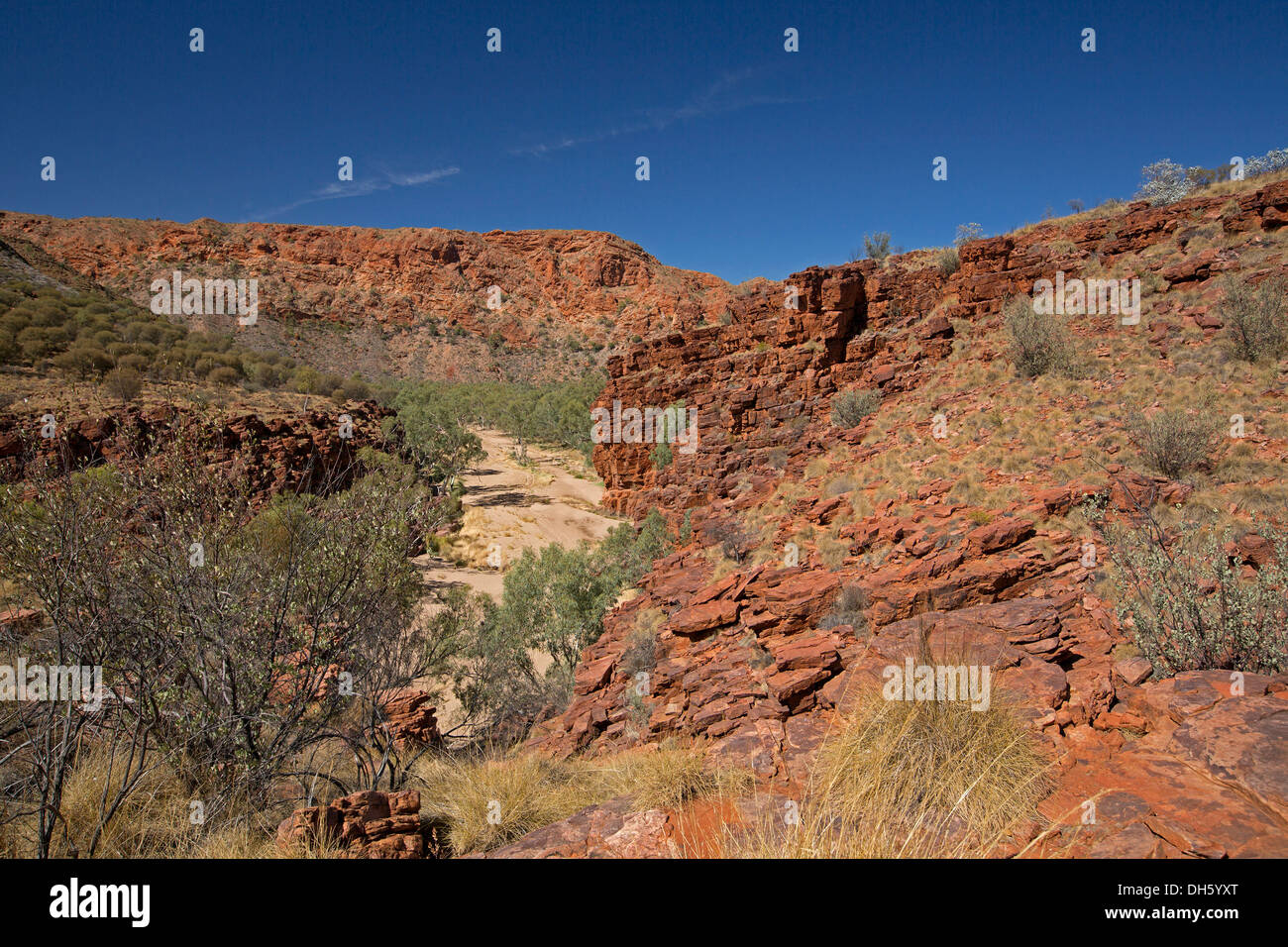 Outback landscape of high rocky cliffs and sandy riverbed in Trephina ...