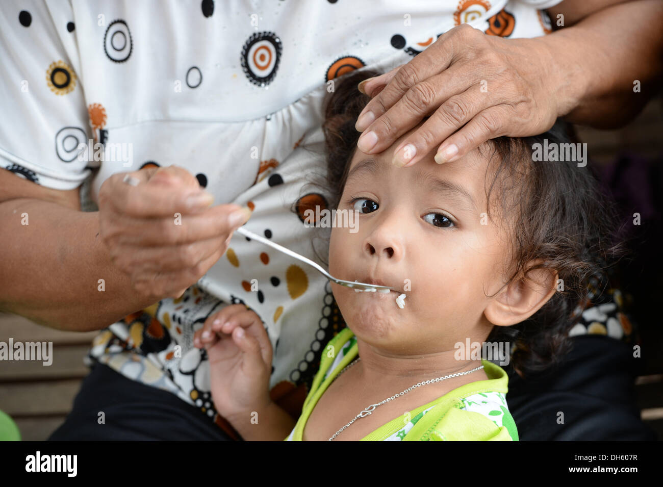 Phnom Penh, Cambodia. 10th Oct, 2013. A child is fed by his mother in ...