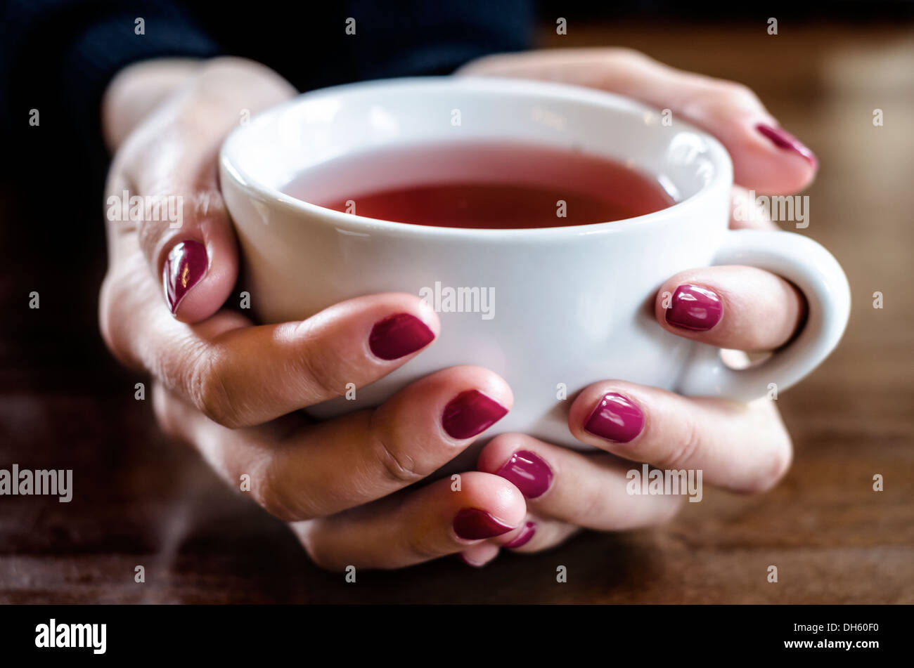 A cup of tea in hand Stock Photo - Alamy