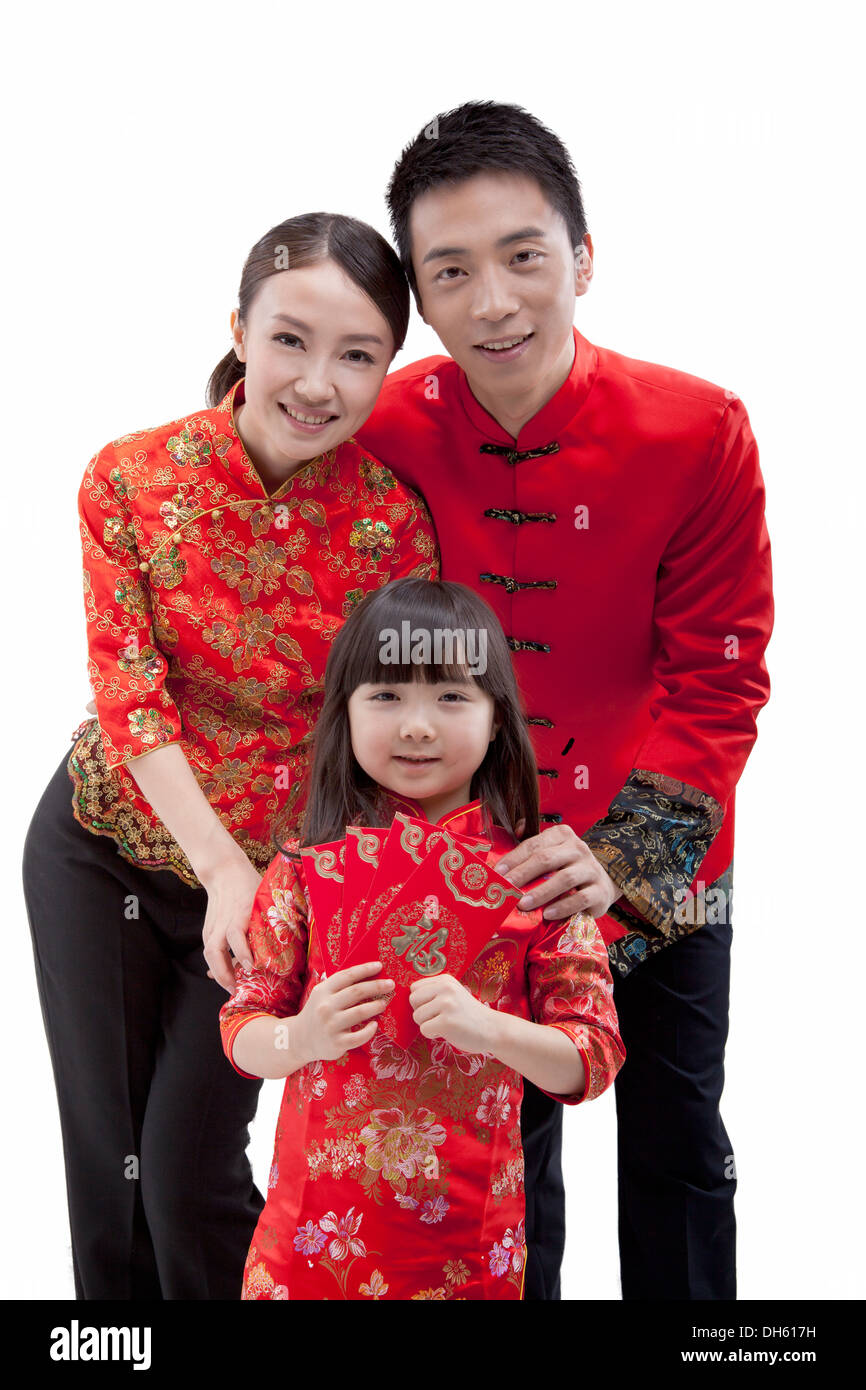 Family of three wearing costume and red envelope Stock Photo - Alamy