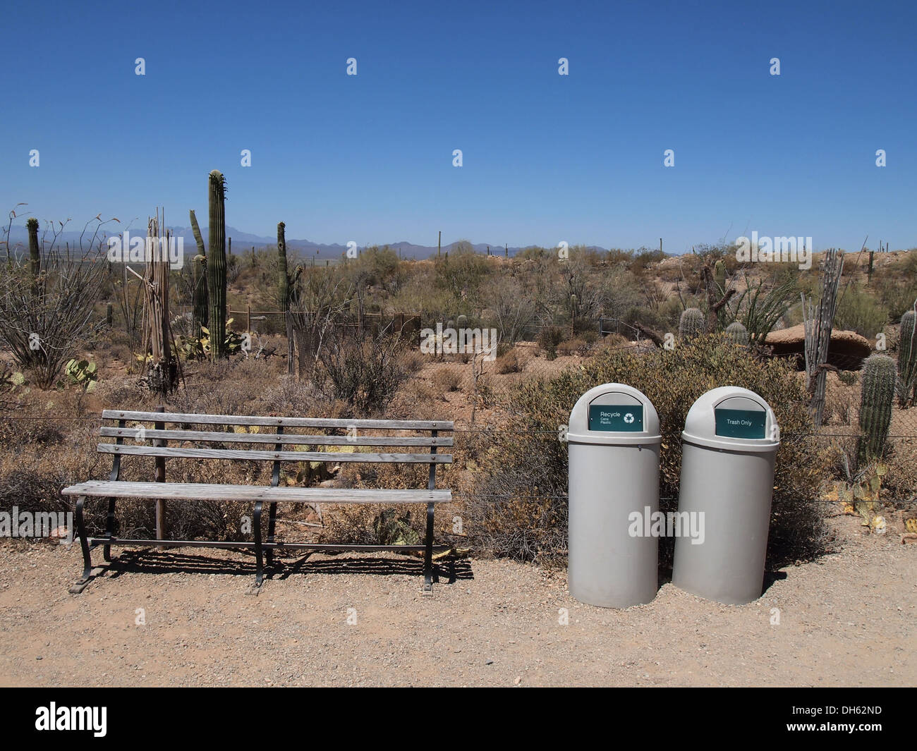 Recycling and trash bins, and park bench along the Desert Loop Trail at ...