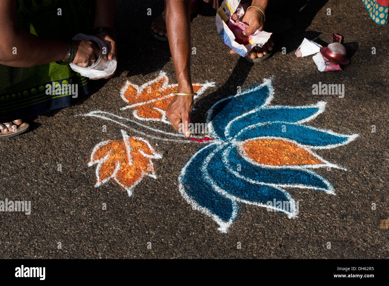 Indian women making a Lotus Rangoli to honor the Sri Sathya Sai Baba ...