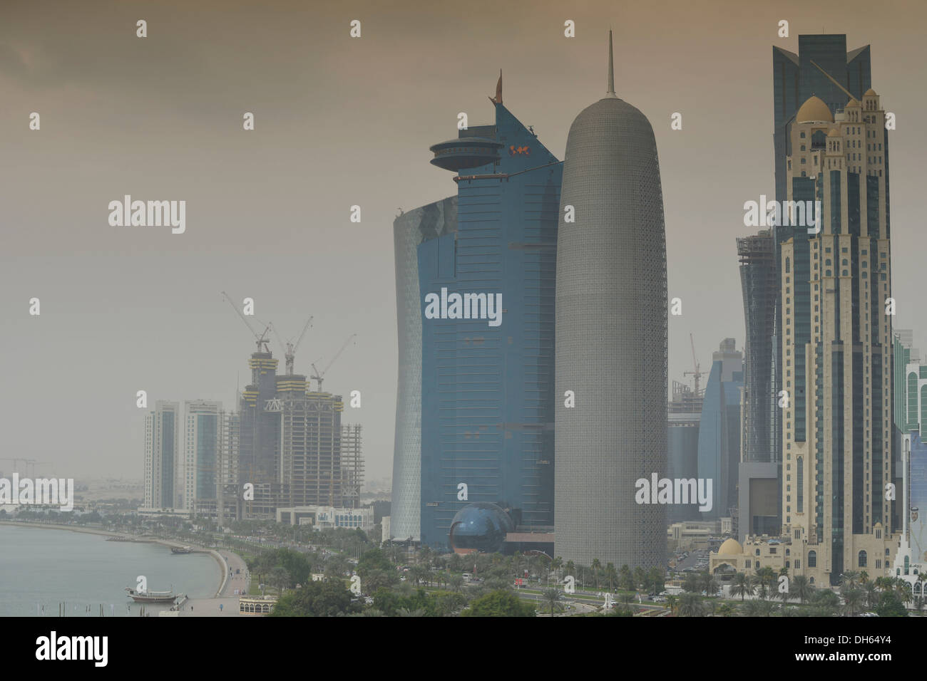 Smog over Corniche waterfront promenade with the skyline of Doha with ...